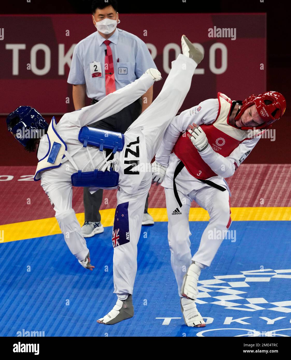 Britain's Bradly Sinden, right, avoids a kick by New Zealand 's Tom ...
