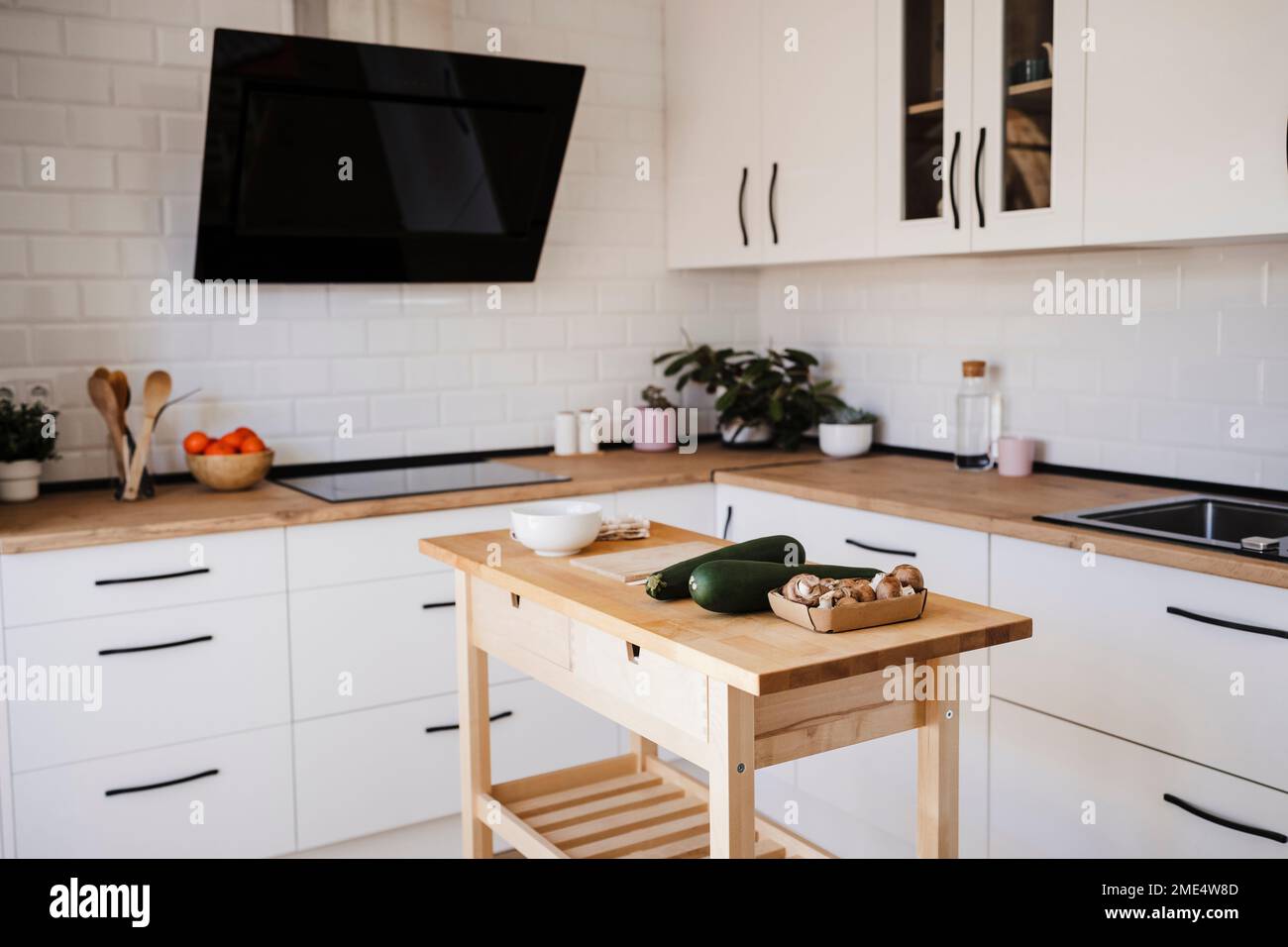 Modern kitchen with vegetables kept on table at home Stock Photo - Alamy