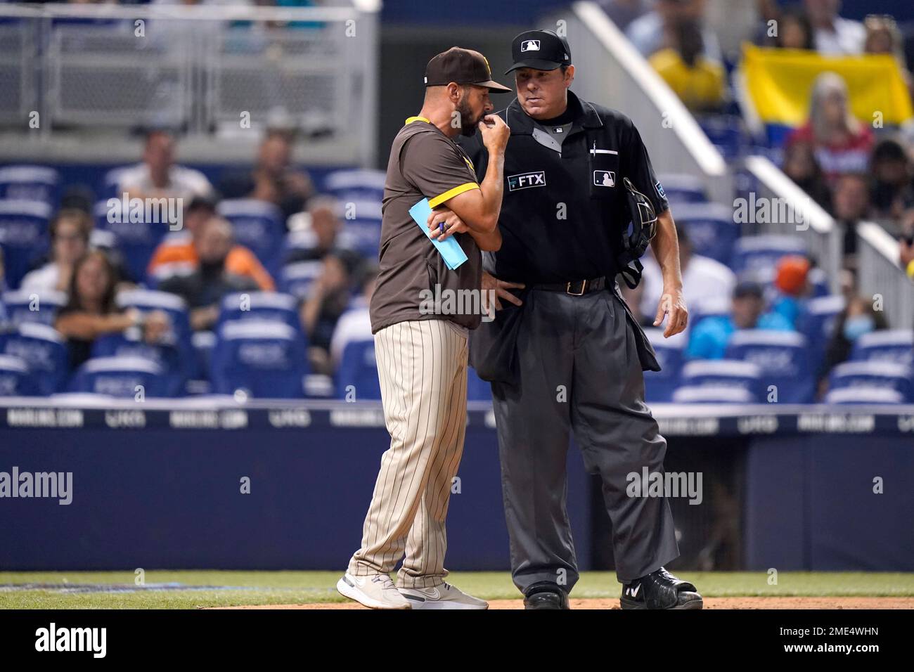 San Diego Padres manager Jayce Tingler, left, talks with home plate ...