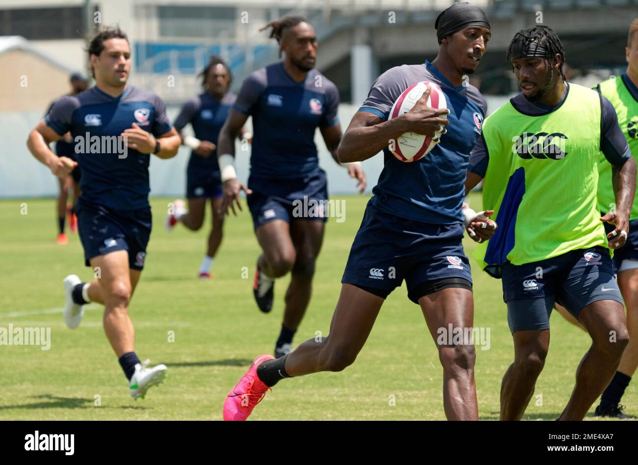 Perry Baker, center right, of the U.S. rugby sevens team runs with a ...