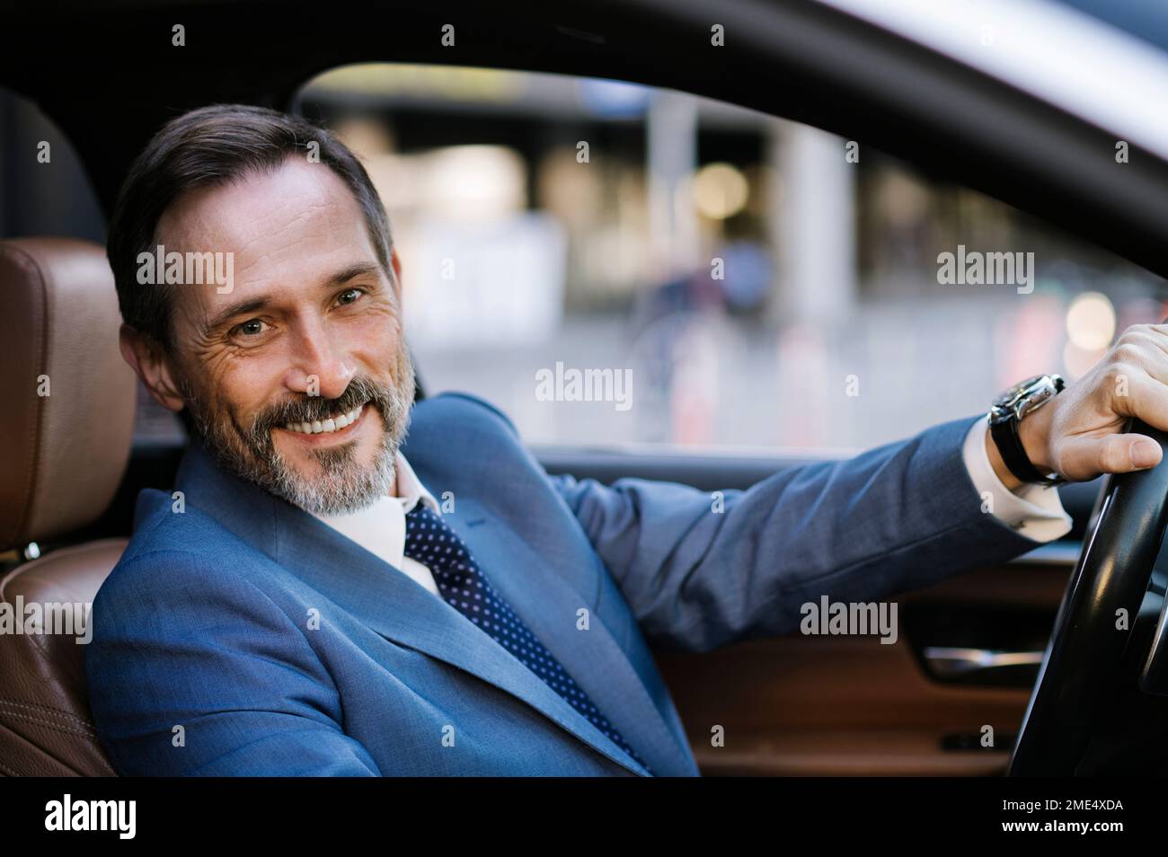 Happy mature businessman driving car Stock Photo - Alamy