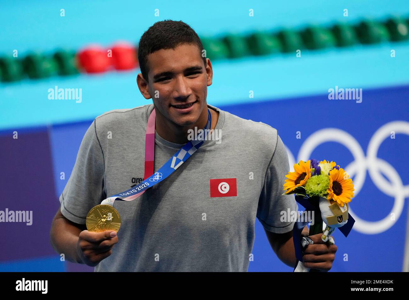 Ahmed Hafnaoui, of Tunisia, celebrates after winning the final of the ...