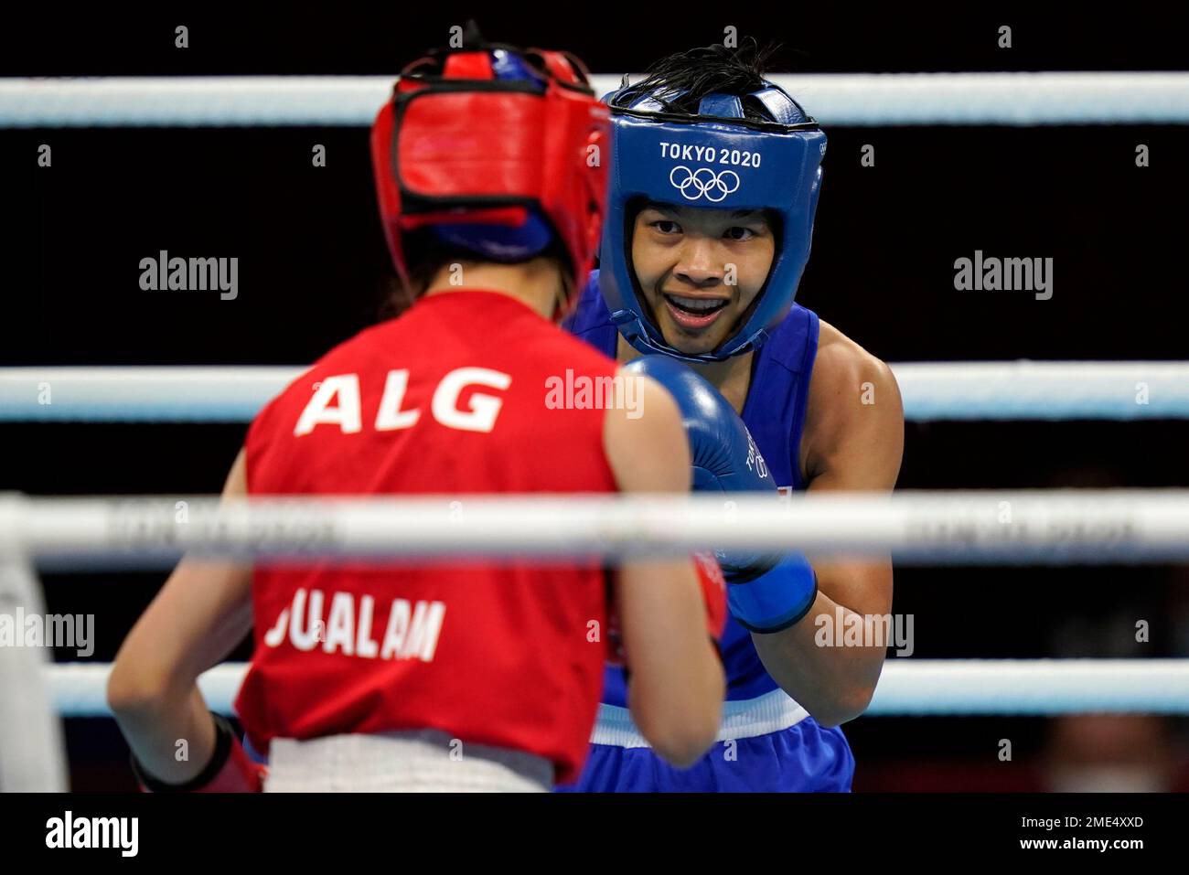 Algeria's Roumaysa Boualam, left, exchanges punches with Thailand's ...
