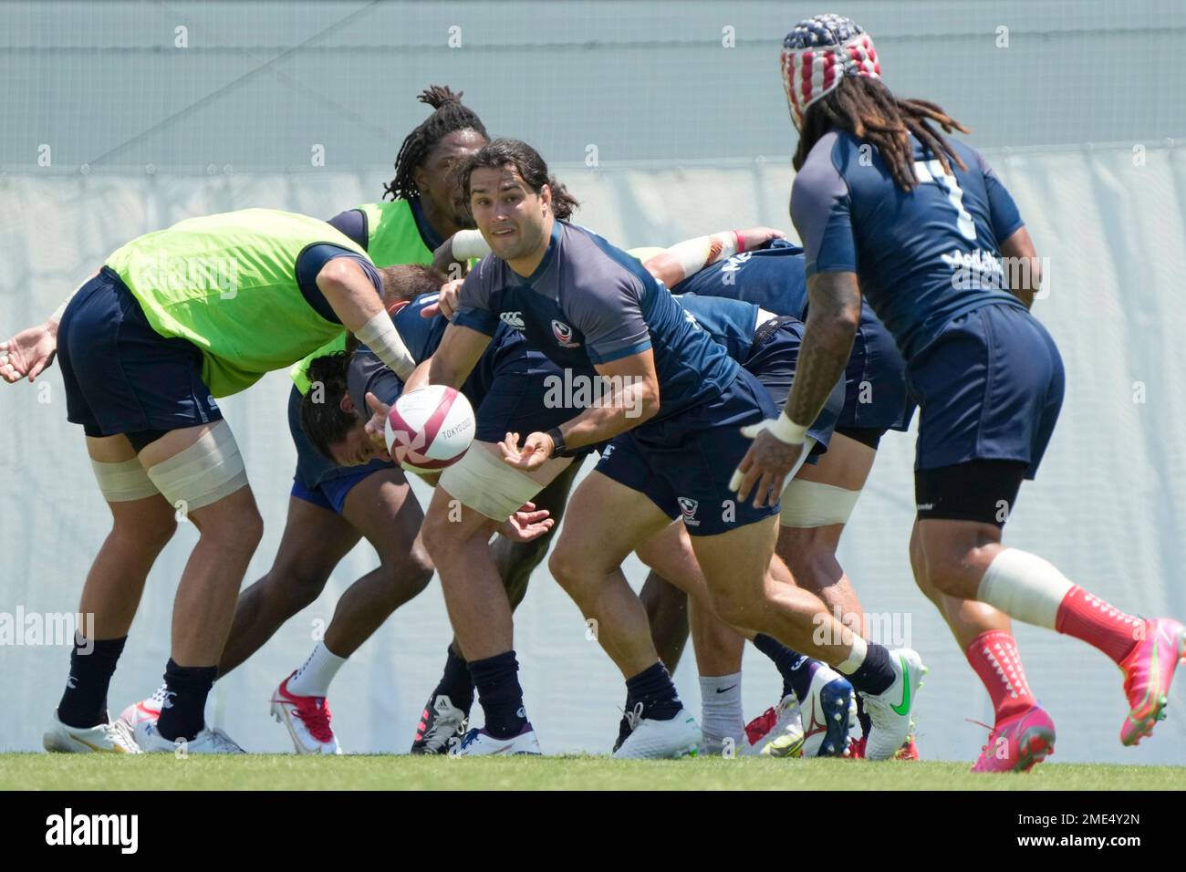 Madison Hughes, center, of the United States rugby sevens team passes a ...