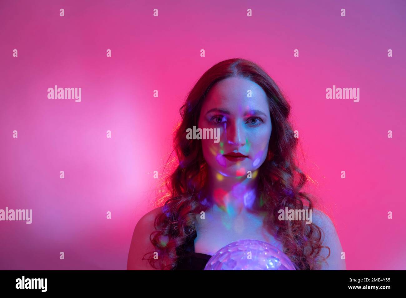 Beautiful young woman with glowing crystal ball Stock Photo - Alamy