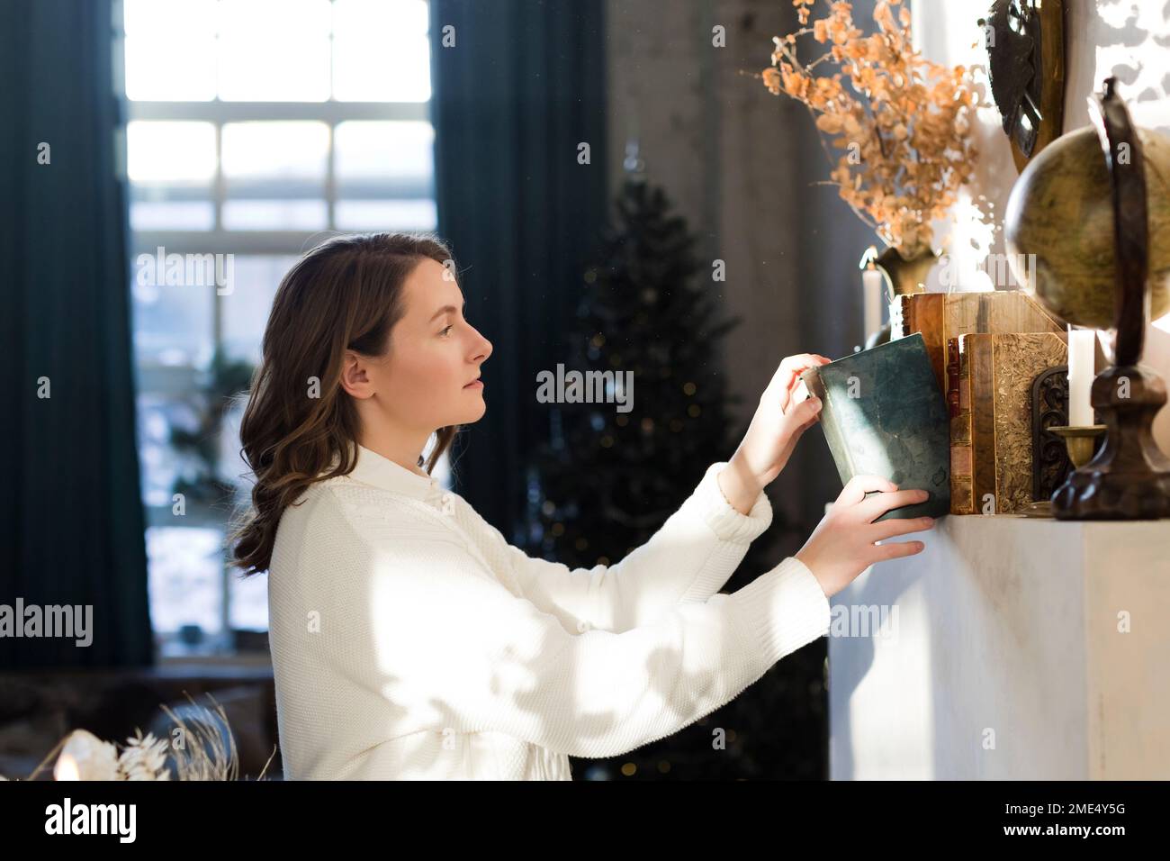 Woman choosing book from shelf at home Stock Photo - Alamy
