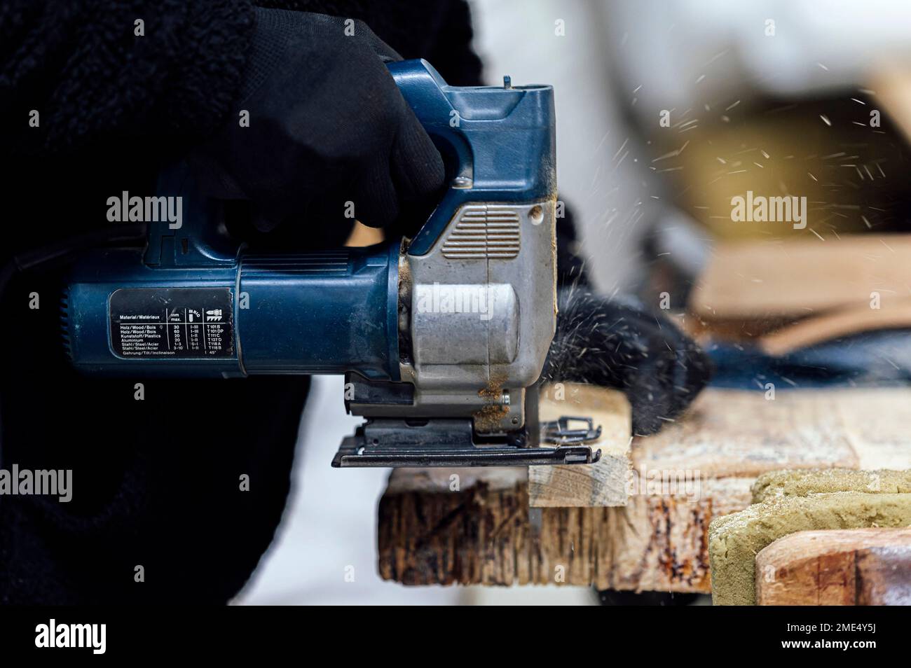 Craftsman using hand saw for cutting wood in workshop Stock Photo - Alamy