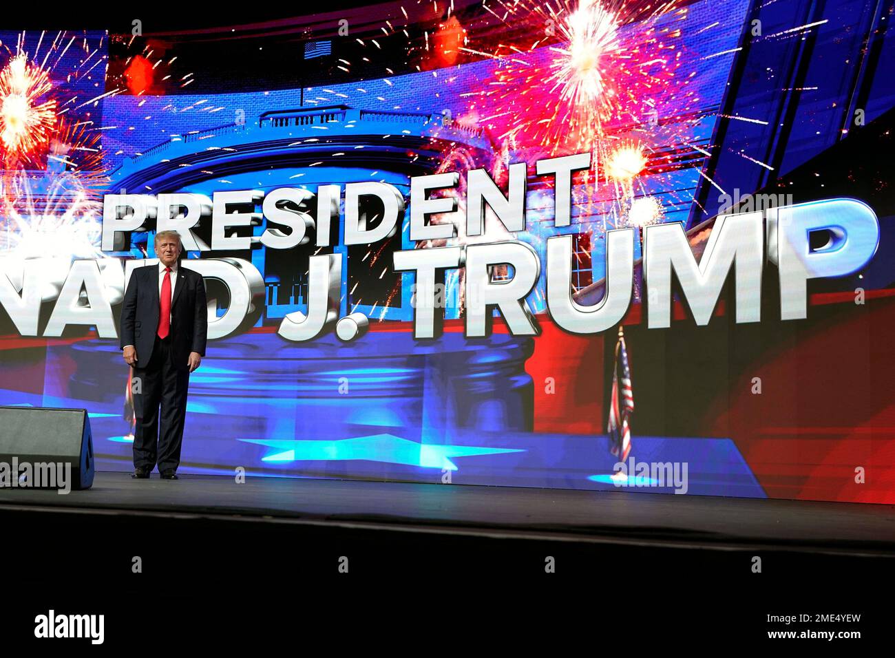 Former President Donald Trump pauses on stage prior to speaking to ...