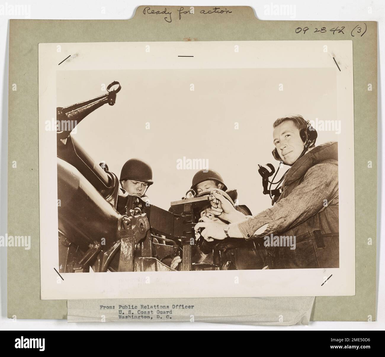 Coast Guardsmen stand ready at their posts, prepared for enemy action ...