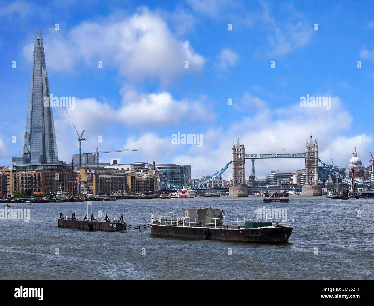 Barge in the Thames River in London, looking west toward Tower Bridge ...