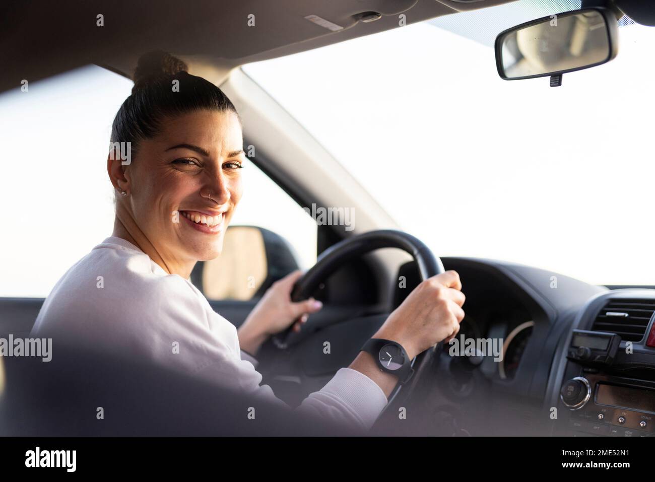 Happy young woman driving car Stock Photo - Alamy