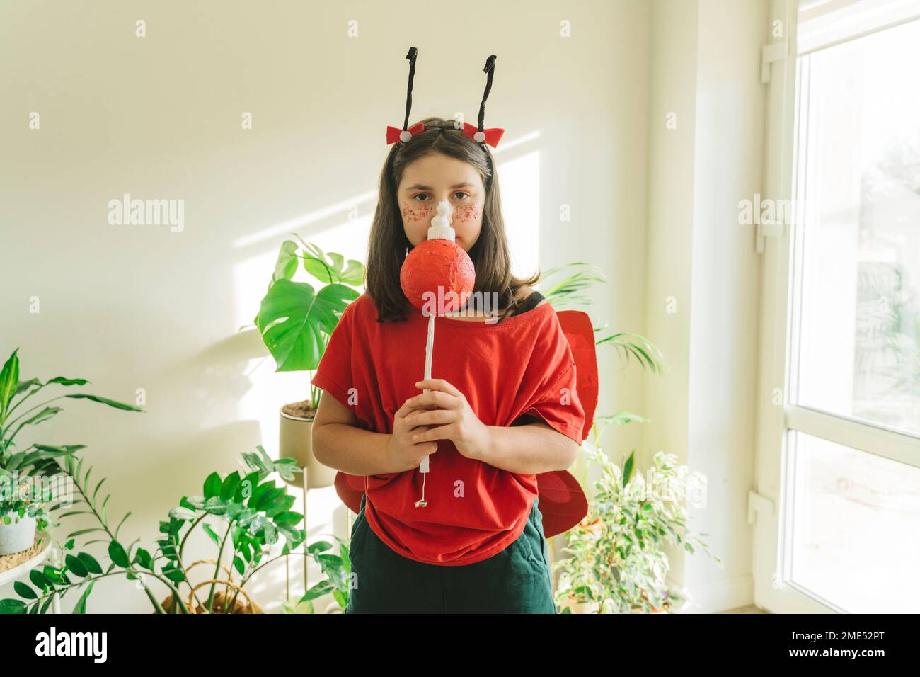 Girl in bug costume standing at home Stock Photo - Alamy