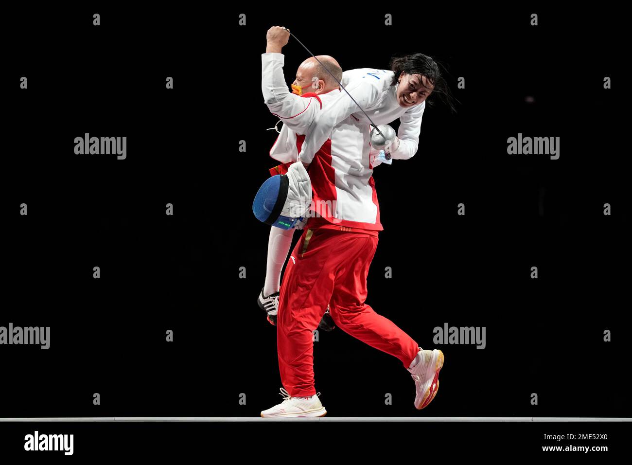 Sun Yiwen of China, left, celebrates with her coach Hugues Obry after ...