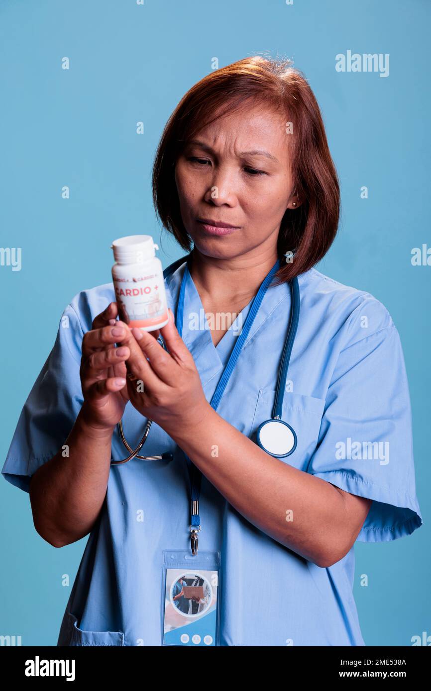 Serious medical assistant working at medication treatment to prevent ...