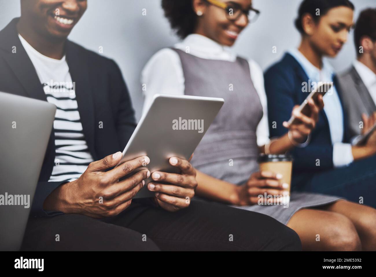 They made the cut. a group of young businesspeople waiting in line for ...