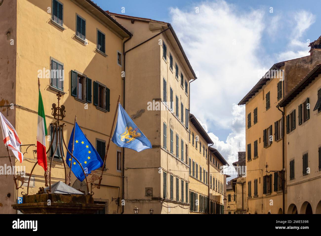 Italy, Tuscany, Poppi, National flags fluttering against old town ...
