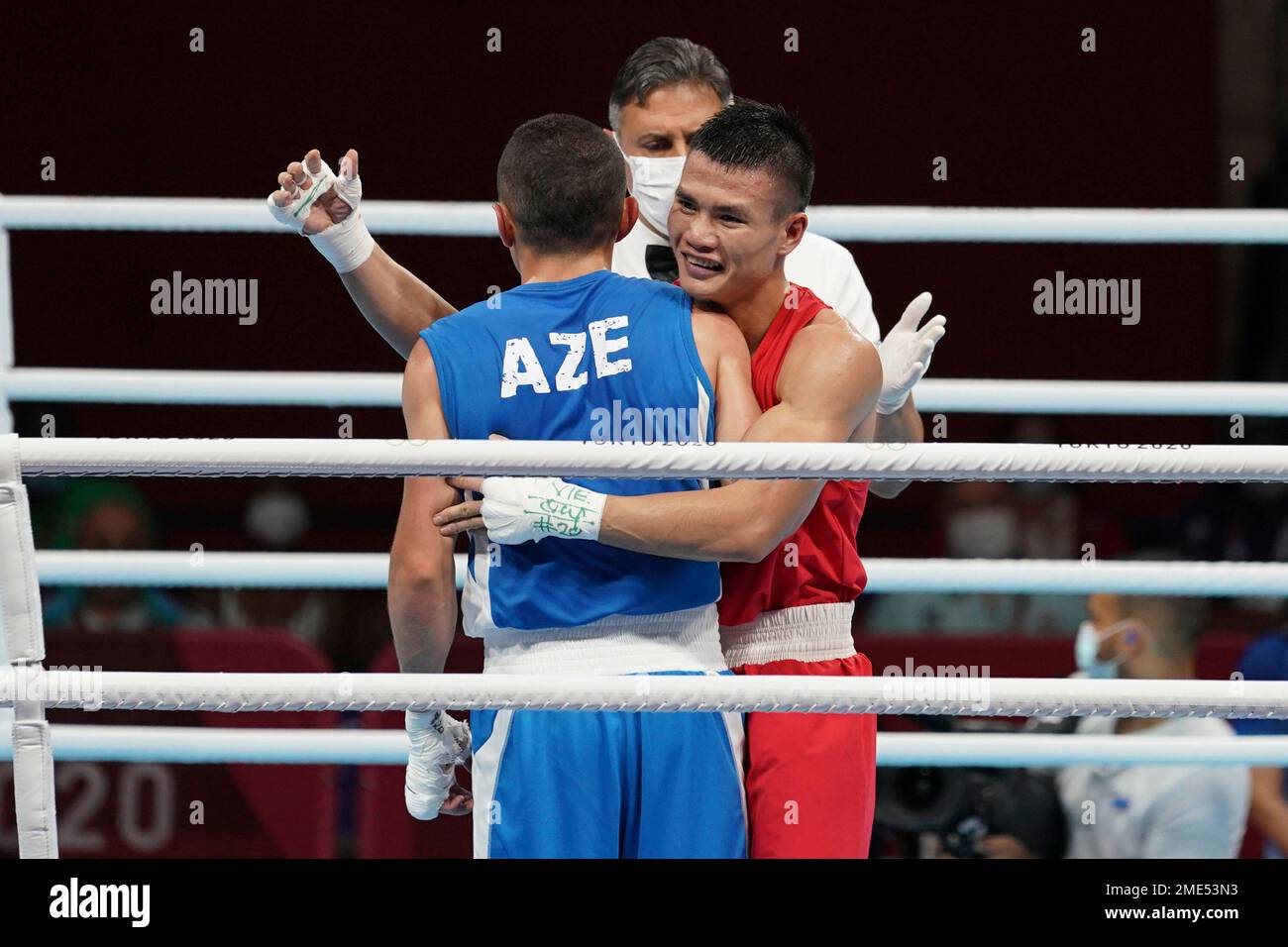 Vietnam's Nguyen van Duong, right, embraces Azerbaijan's Tayfur Aliyev ...