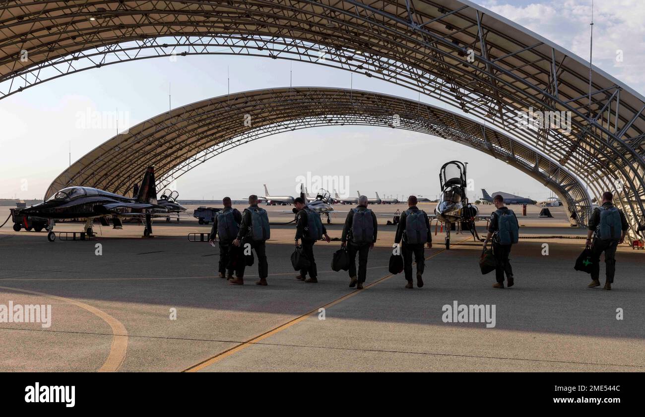 T-38 Talon pilots walk to their aircraft in preparation for a flyover ...