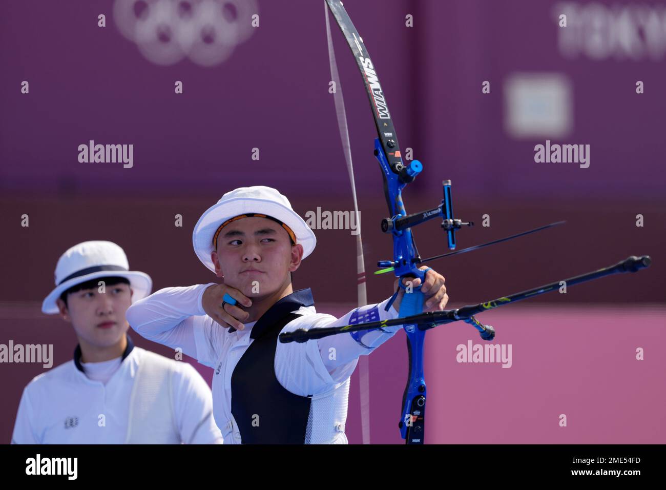 South Korea's Kim Je Deok releases an arrow flanked by his teammate An ...