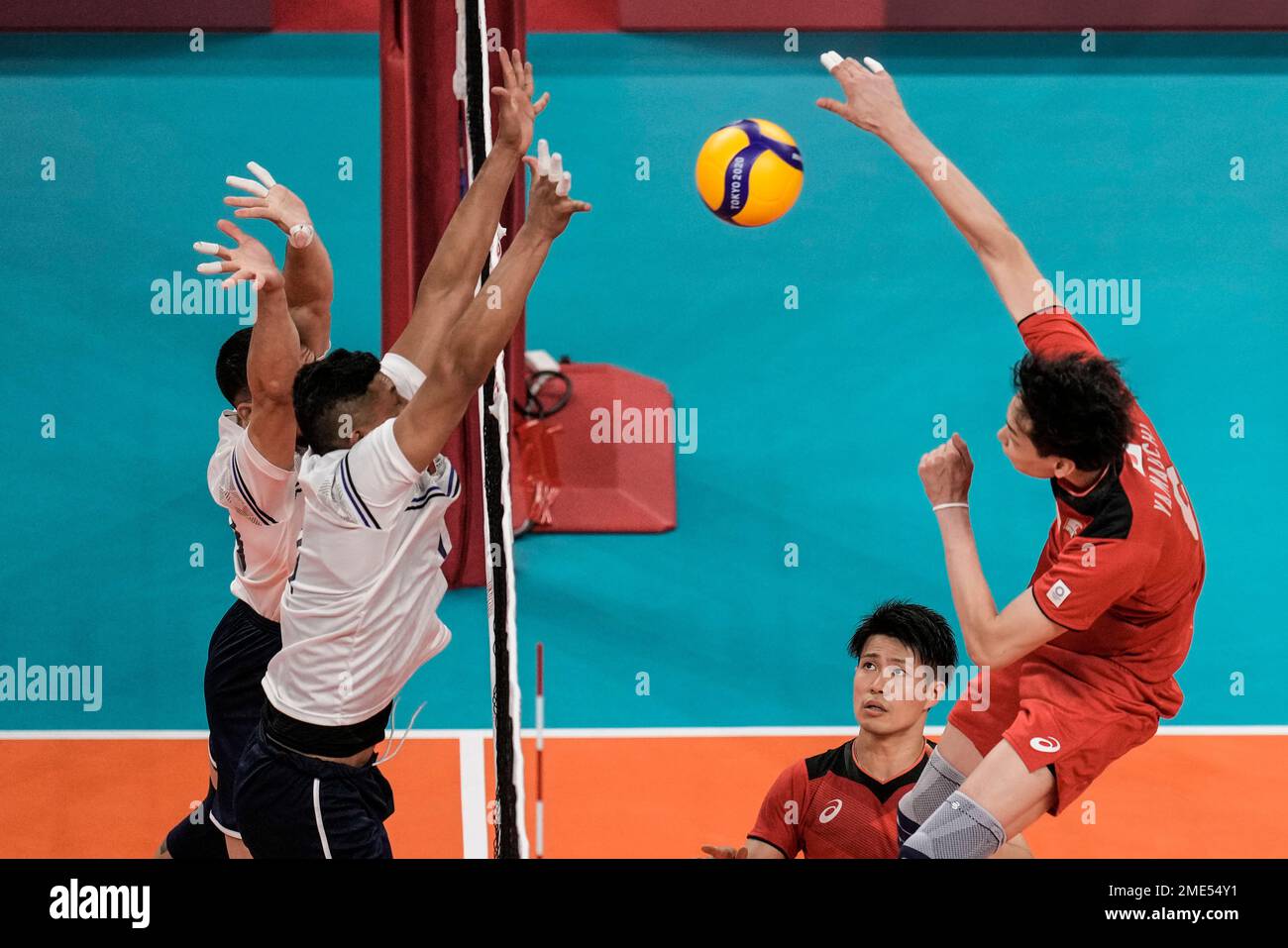 Japan's Ran Takahashi, right, hits the ball during the men's volleyball ...