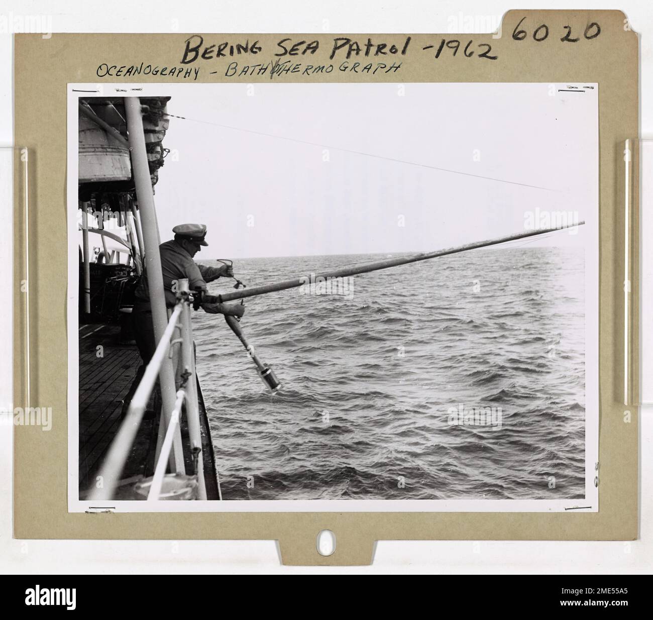 Chief Aerographer’s Mate Donald C. Bailey retrieves a bathythermograph ...