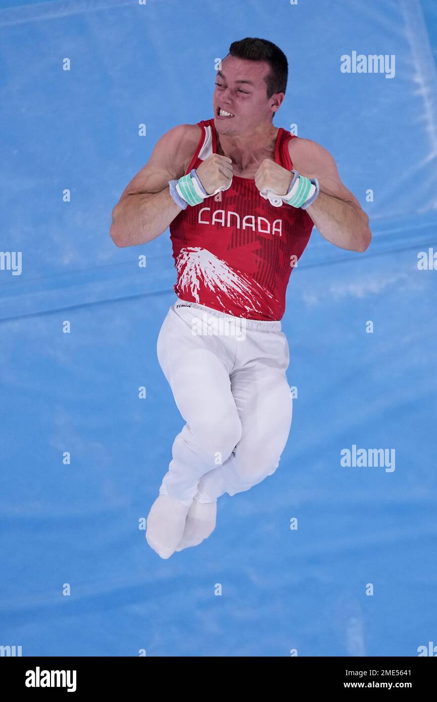 Rene Cournoyer, of Canada, performs on the rings during men's artistic ...