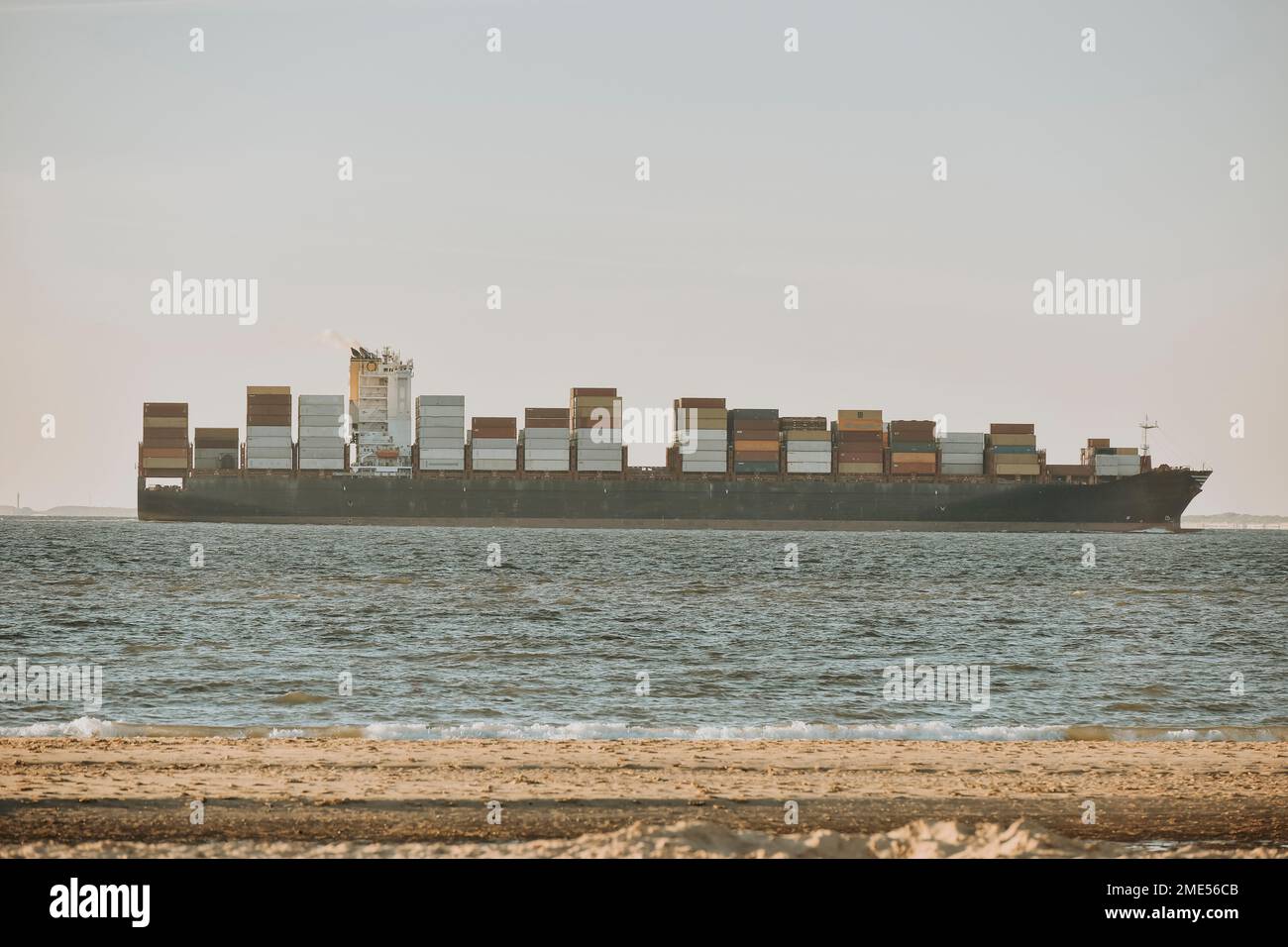 Netherlands, Zeeland, Groede, Container ship with beach in foreground ...