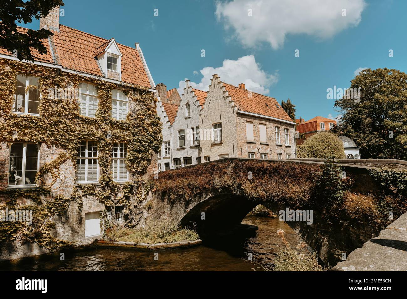Belgium, West Flanders, Bruges, Old arch bridge over city river Stock ...