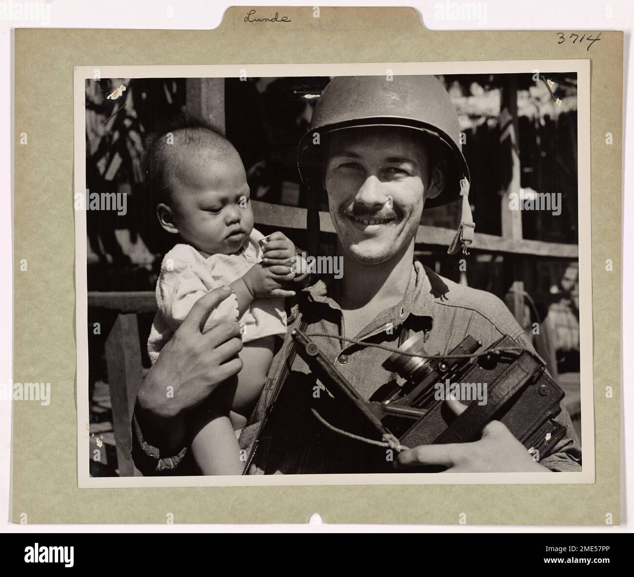 Coast Guardsman James C. W. Lunde, a combat photographer, meets a young ...