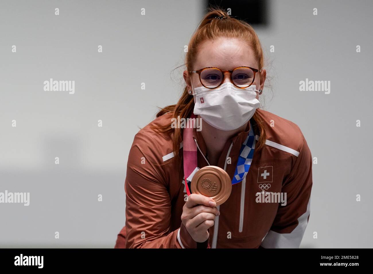Nina Christen, of Switzerland, holds her bronze medal after winning it ...
