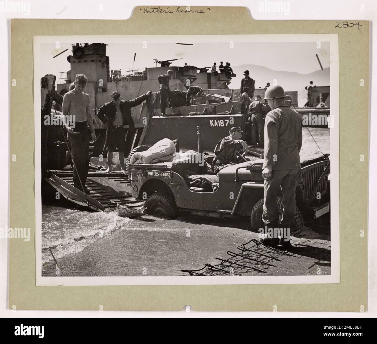 An Army jeep, marked with the nickname 'Hitler's Hearse,' struggles ...
