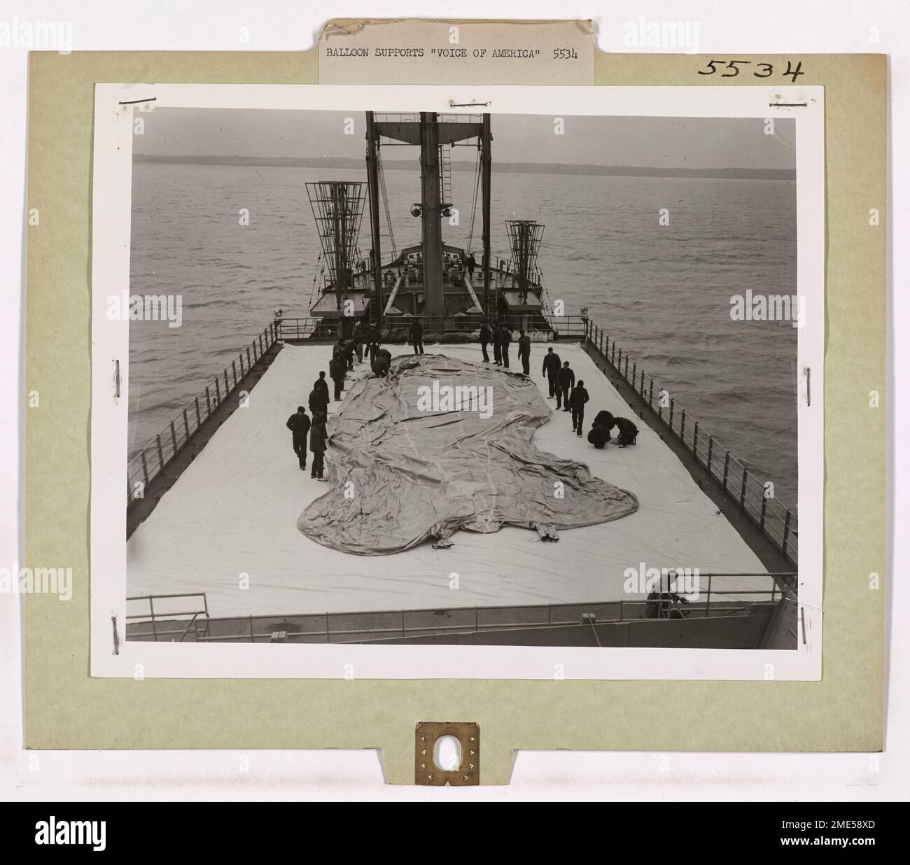 Coast Guard personnel prepare to inflate a captive balloon, which will ...