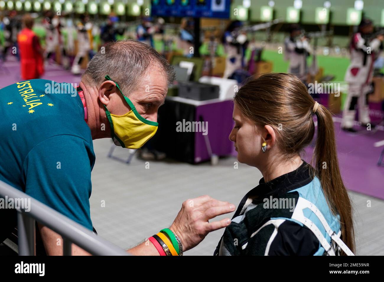 Katarina Rose Kowplos, right, of Australia, speaks with her coach as ...