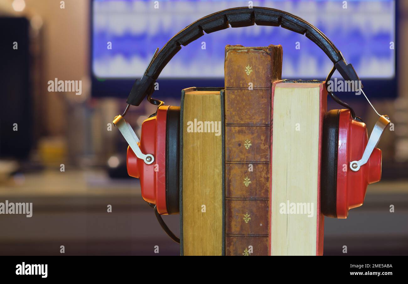 audio book concept with row of books and vintage headphones,blurred ...