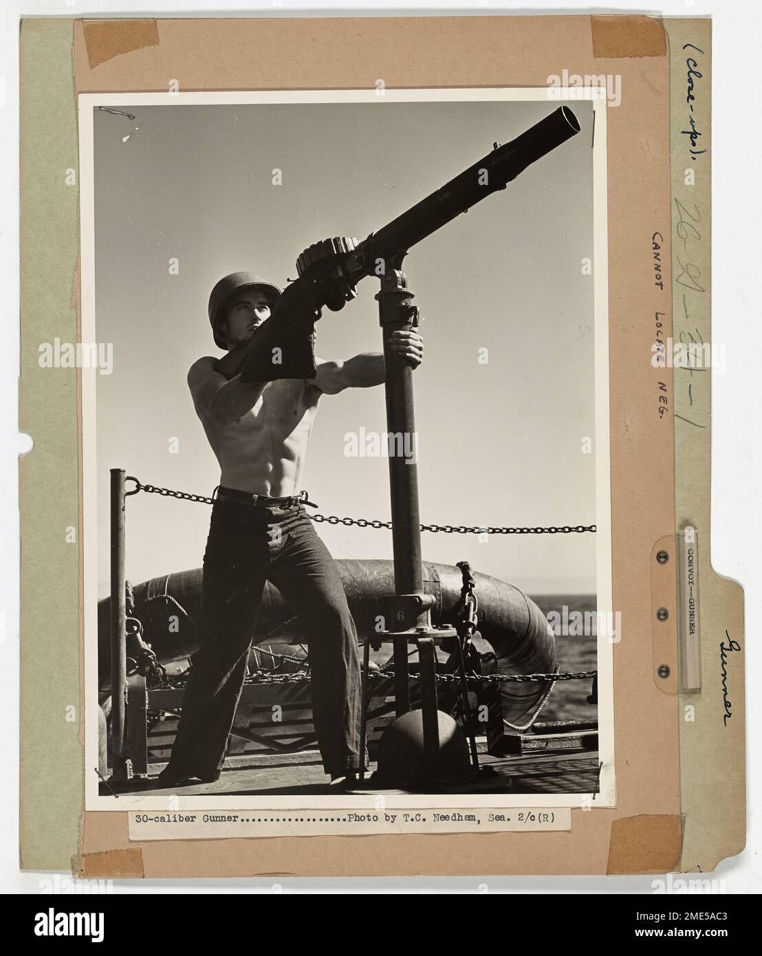 A Coast Guard gunner operates a 30-caliber gun during a military ...