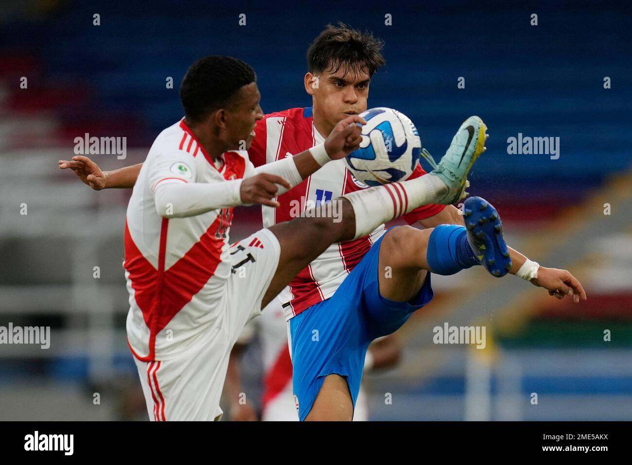 Peru's Alvaro Rojas, left, and Paraguay's Leonardo Rolon battle for the ...
