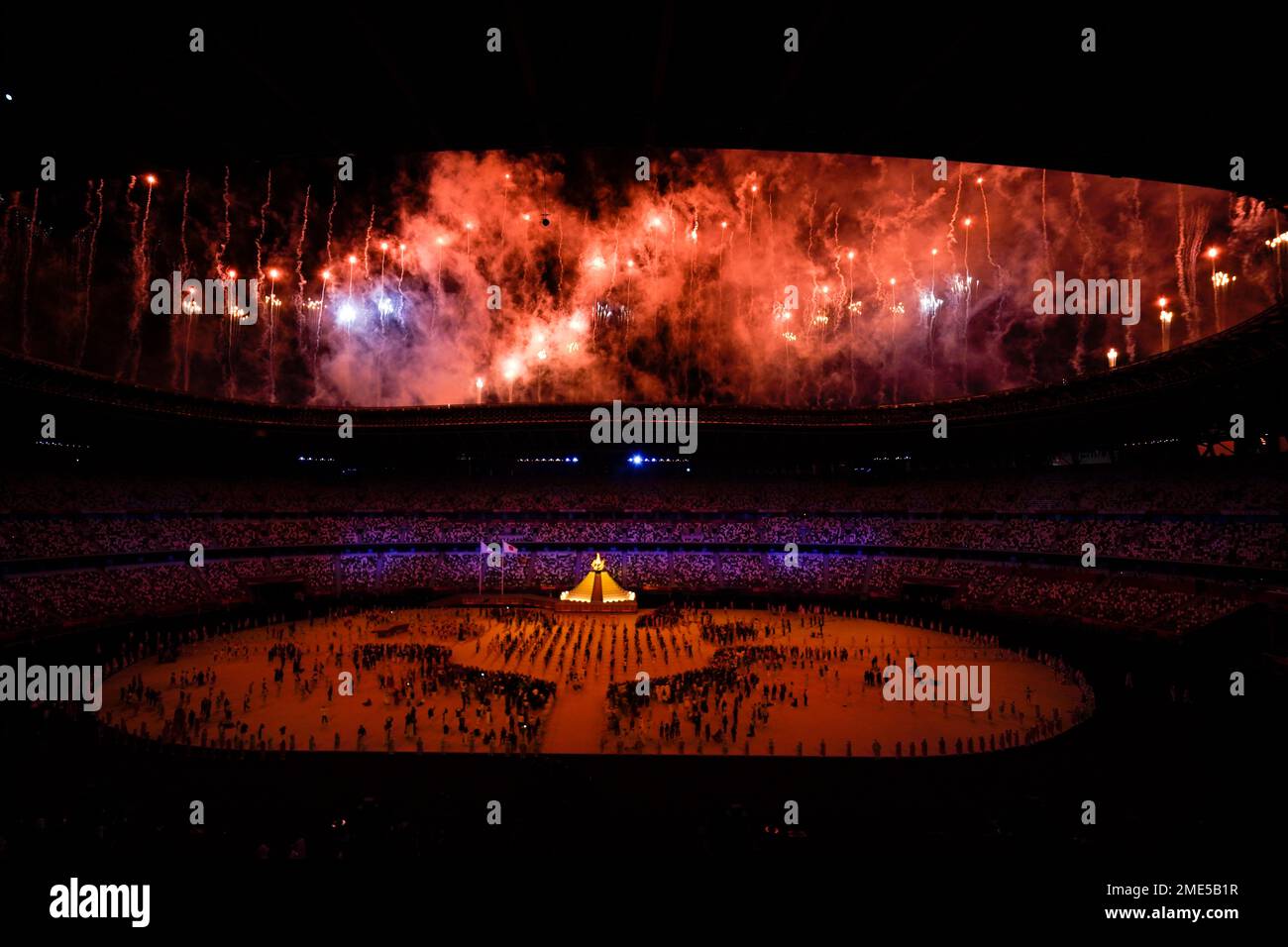 The Olympic flame burns as fireworks explode during the opening ...