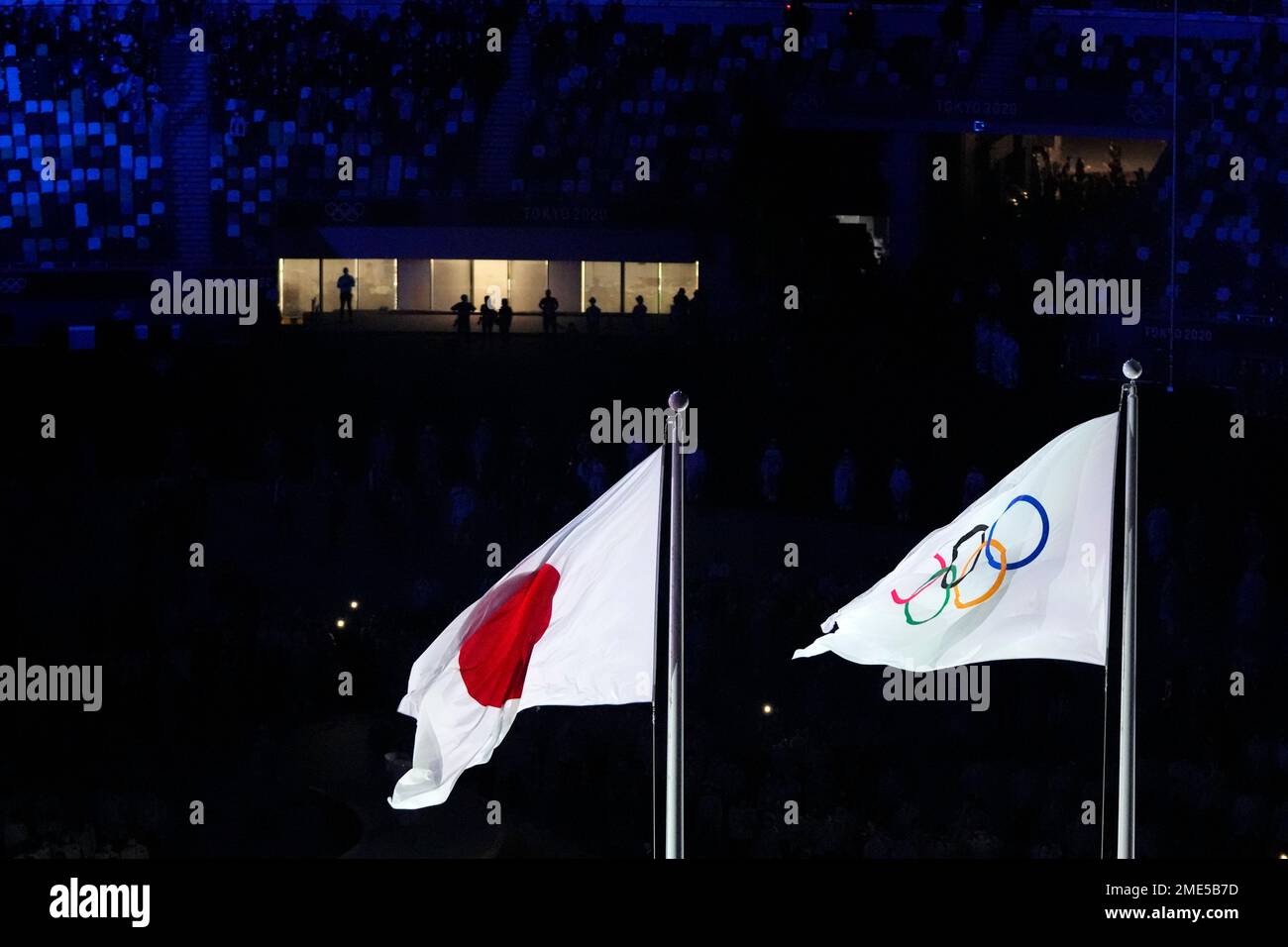 The flags of Japan and the Olympics wave during the opening ceremony in ...