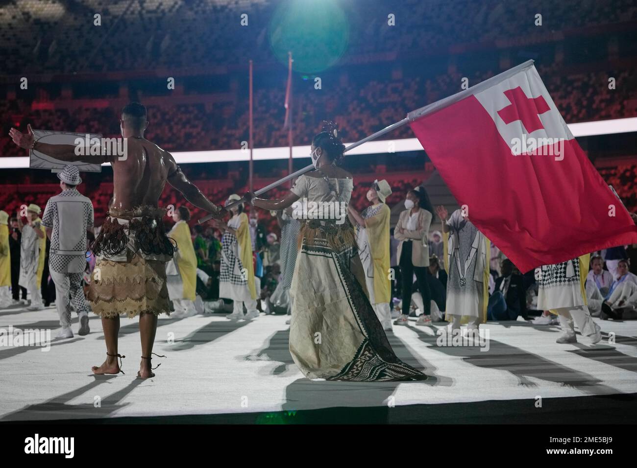 Malia Paseka and Pita Taufatofua, of Tonga, carry their country's flag ...