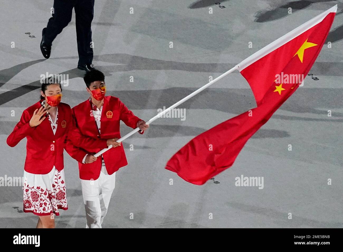 Zhu Ting and Zhao Shuai, of China, carry their country's flag during ...
