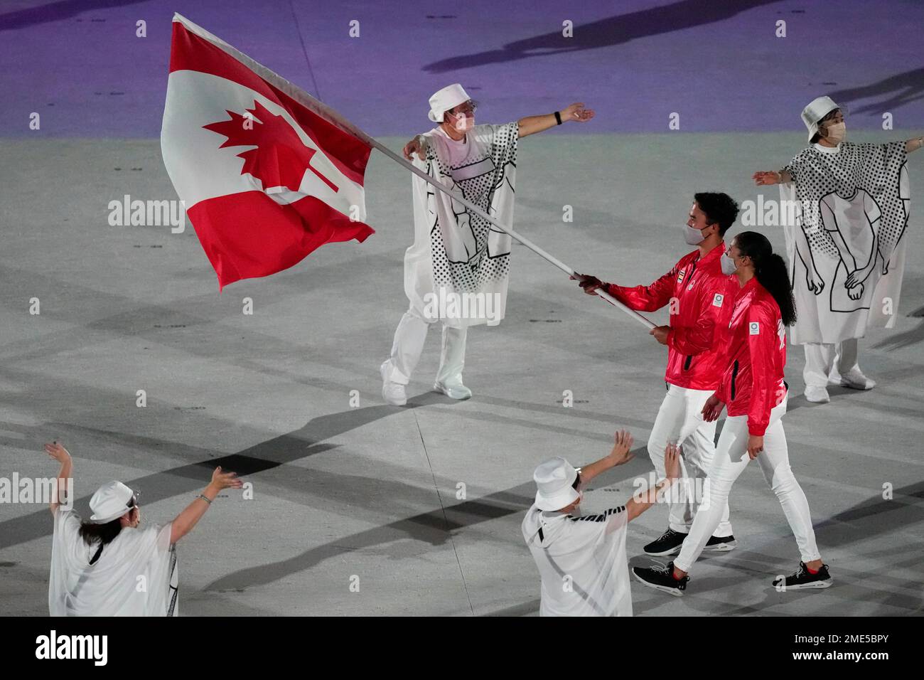 Miranda Ayim and Nathan Hirayama, of Canada, carry their country's flag ...