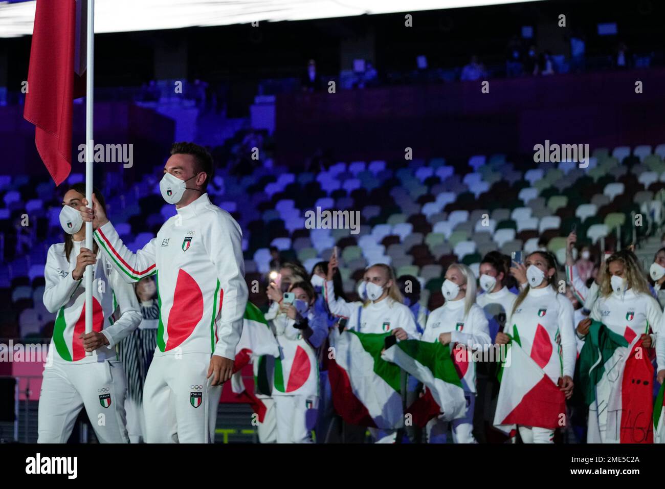 Jessica Rossi and Elia Viviani, of Italy, carry their country's flag ...