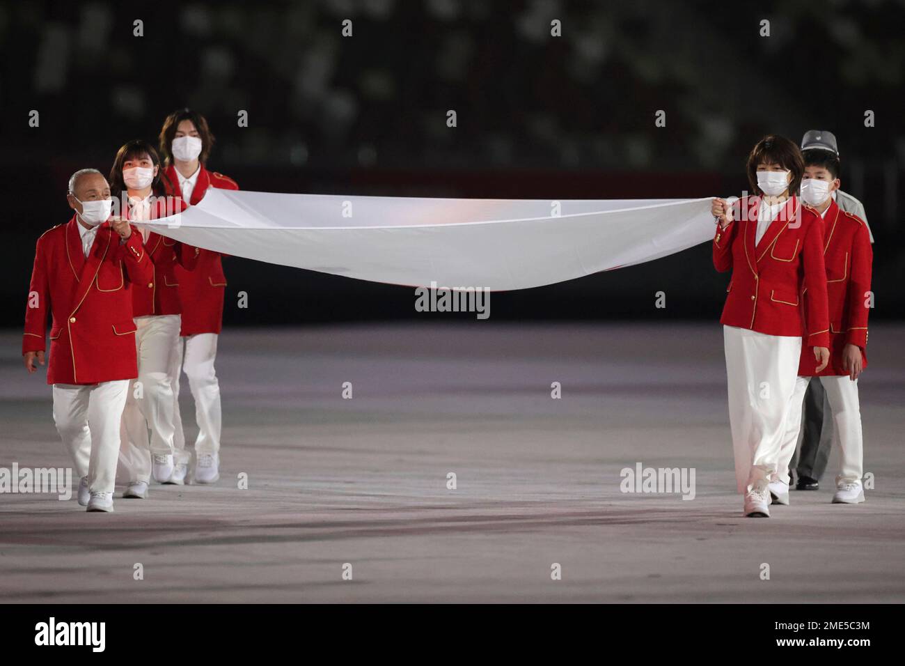 The Japanese flag is carried in during the opening ceremony in the ...