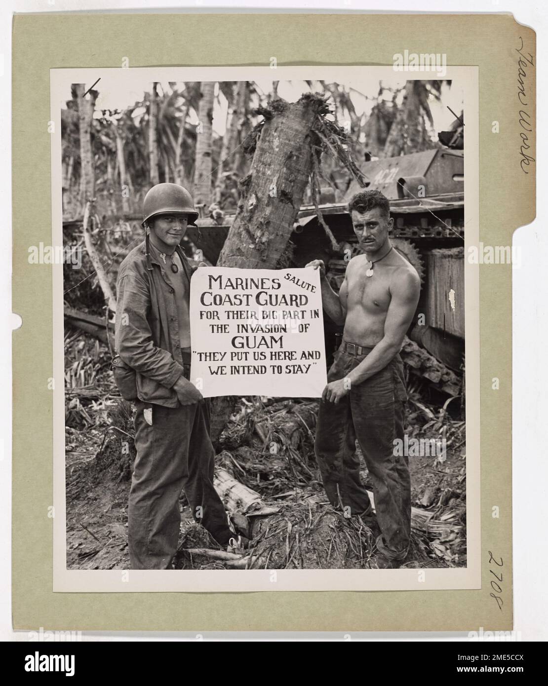 U.S. Marines salute Coast Guardsmen after the victory in Guam, where ...