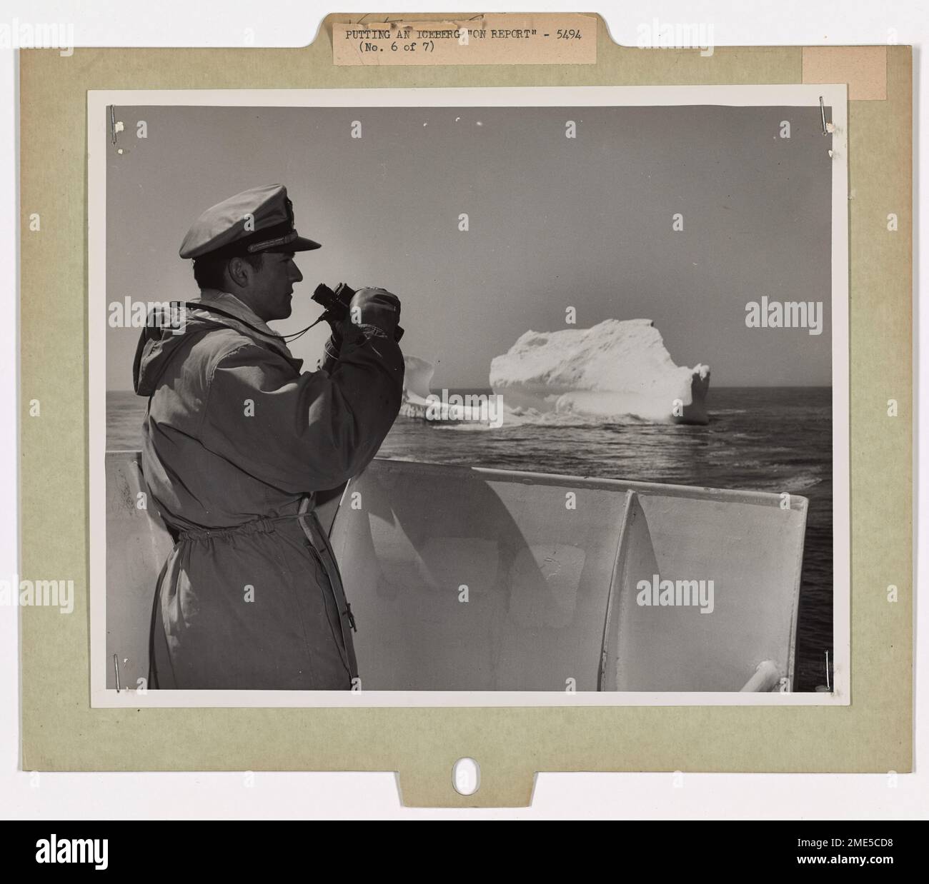 A U.S. Coast Guard officer on the International Ice Patrol examines an ...