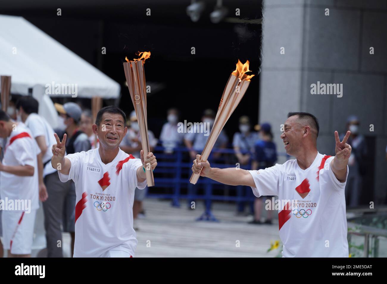 Torchbearers flash v-signs during the final Olympic torch relay event ...