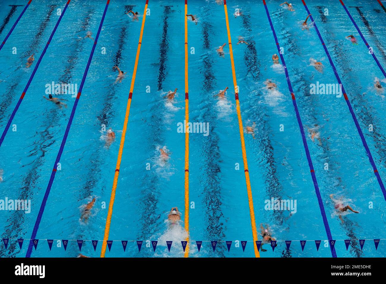 Athletes exercise during a swimming training session at the Tokyo ...