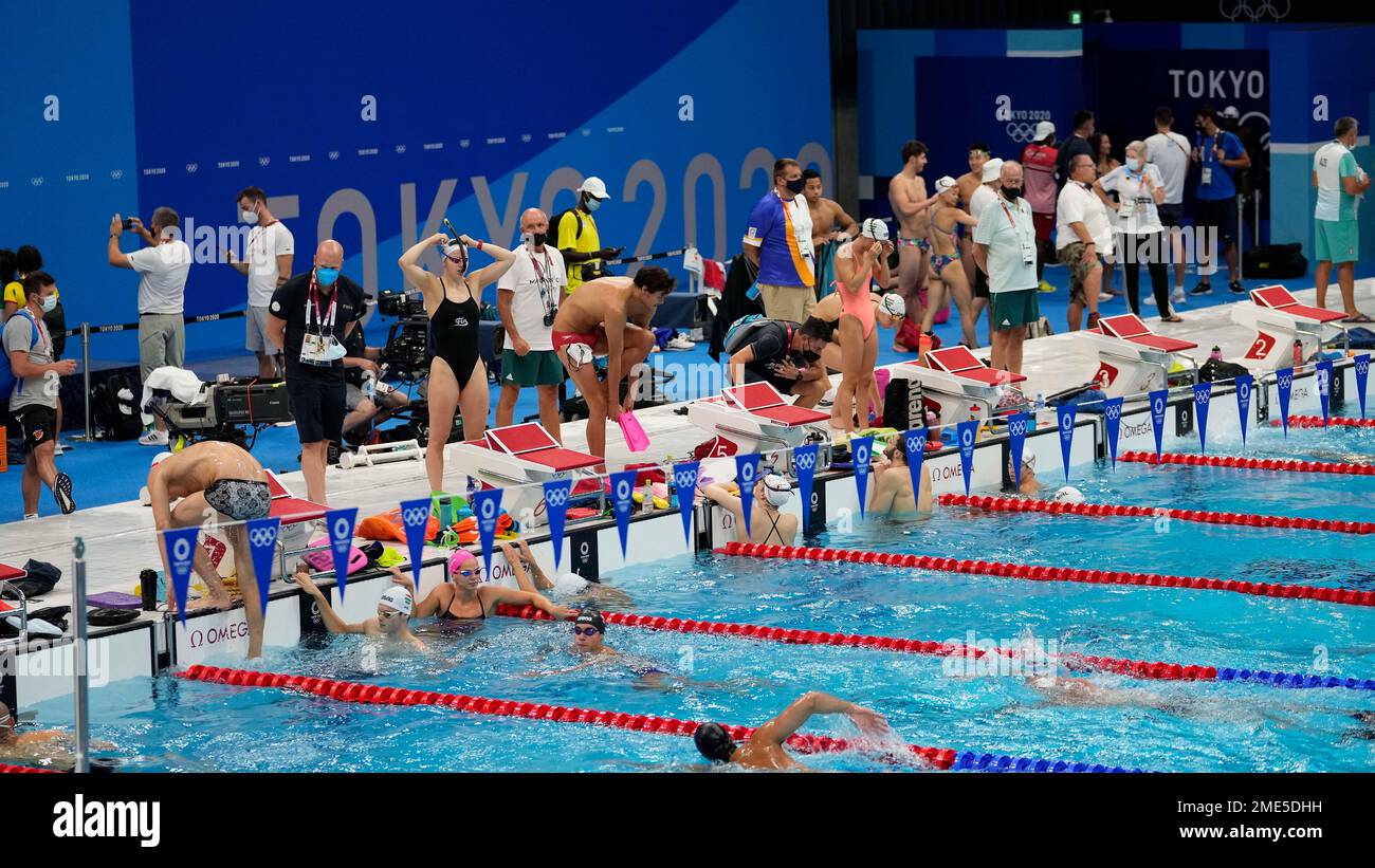 Athletes exercise during a swimming training session at the Tokyo ...