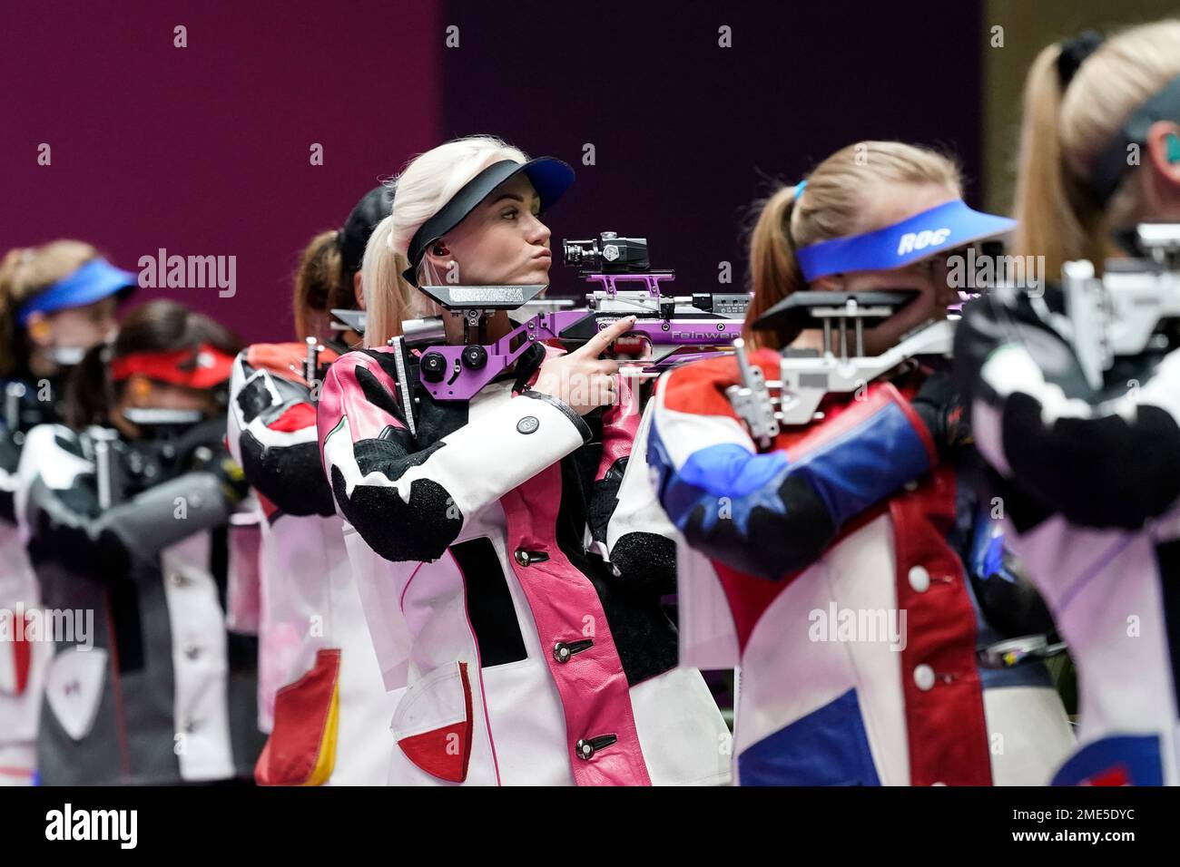 Anna Nielsen, center, of Denmark, practices at the Asaka Shooting Range ...