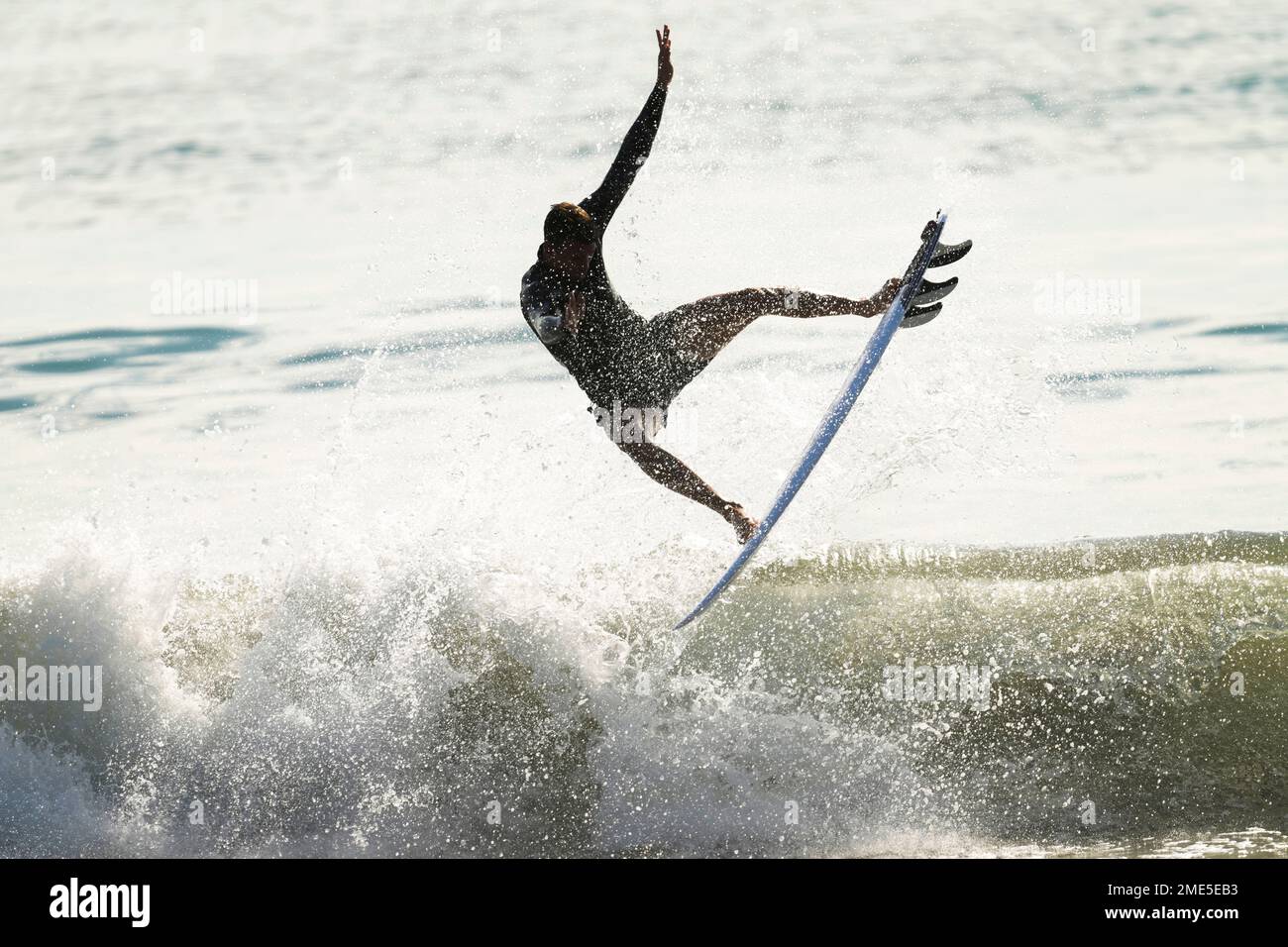 Germany's Leon Glatzer goes airborne as he rides a wave during a surf ...